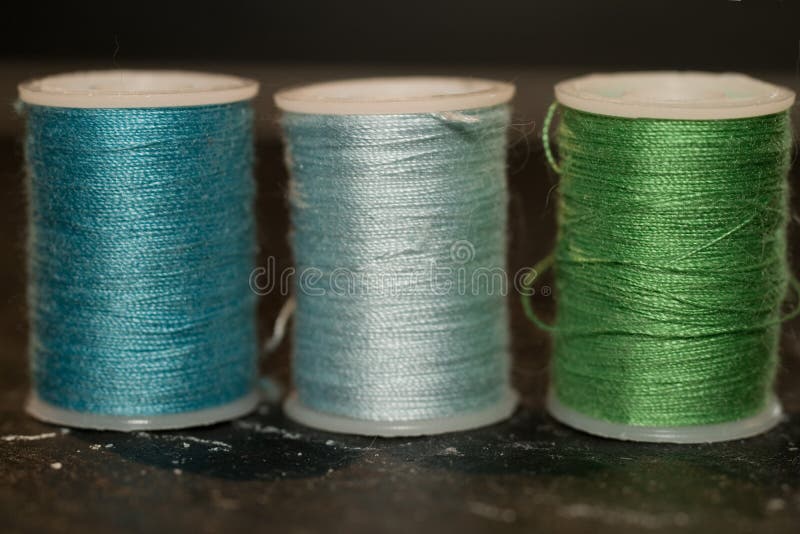 Closeup Shot of Three Green and Blue Thread Spools Stock Image - Image ...