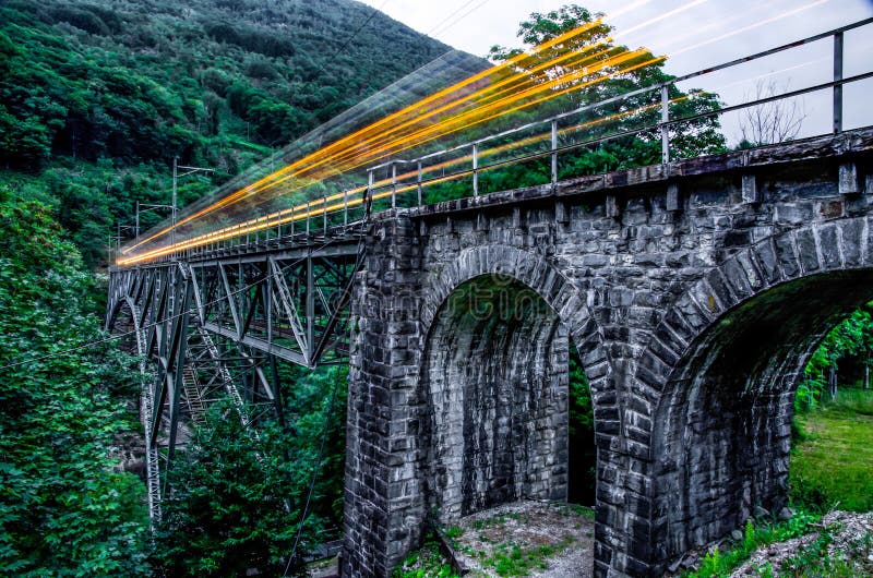 Closeup Shot of a Train Passing the Bridge with Arcs in Log Exposure in ...