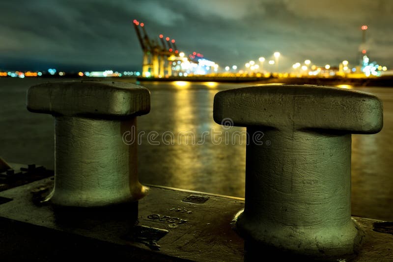 Closeup Shot of Two Short Stone Columns at the Edge of a River at Night ...
