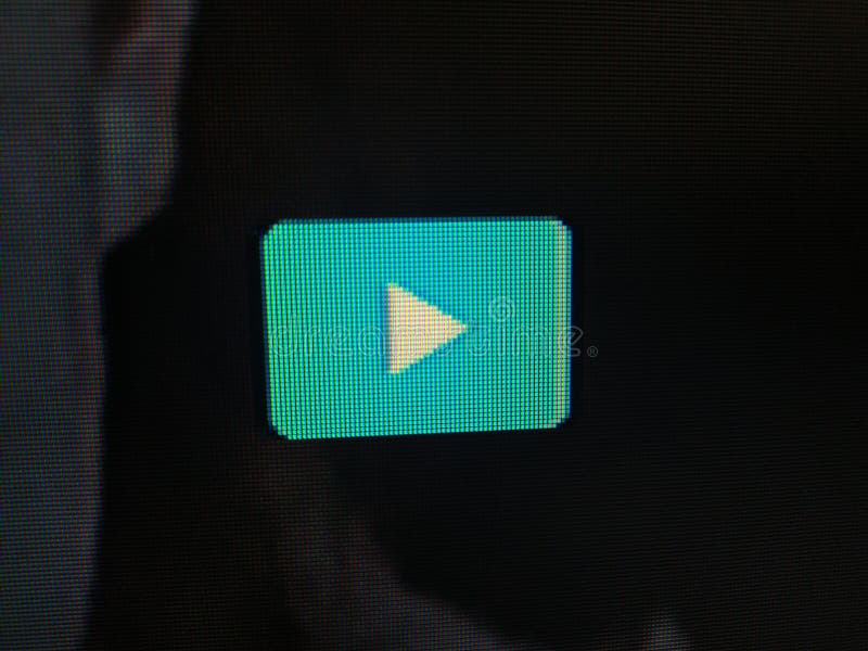 Closeup Shot of a Vibrant Teal Play Button on a Dark Screen, Showcasing ...