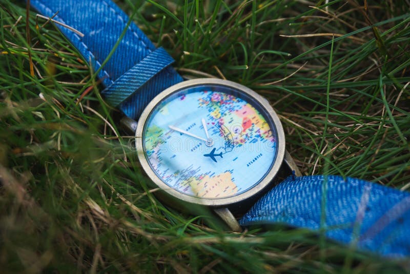 Closeup Shot of a Watch with a Design of the World Map on the Grassy ...