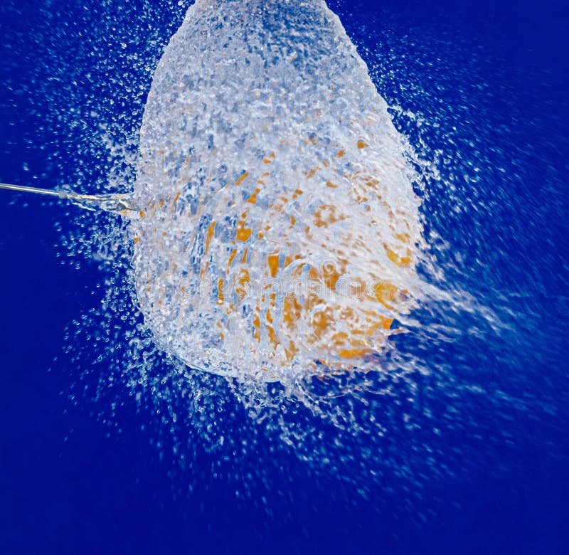 Closeup Shot Of A Water Balloon Splash With A Blue Background Stock ...