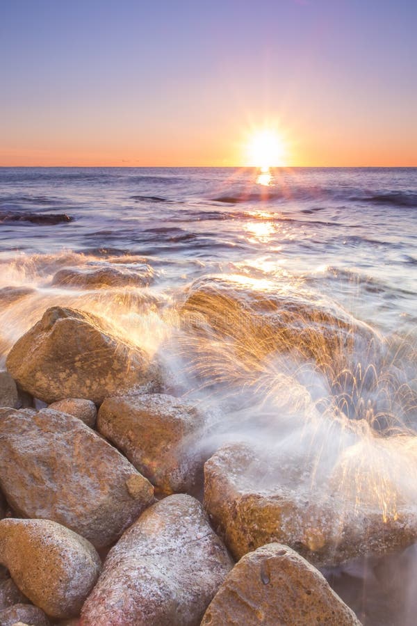 Closeup Shot of Waves Hitting a Rocky Shore during Sunset Stock Photo ...
