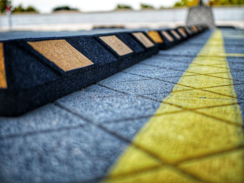 Closeup Shot of a Wheel Stopper in a Parking Lot Stock Photo - Image of ...