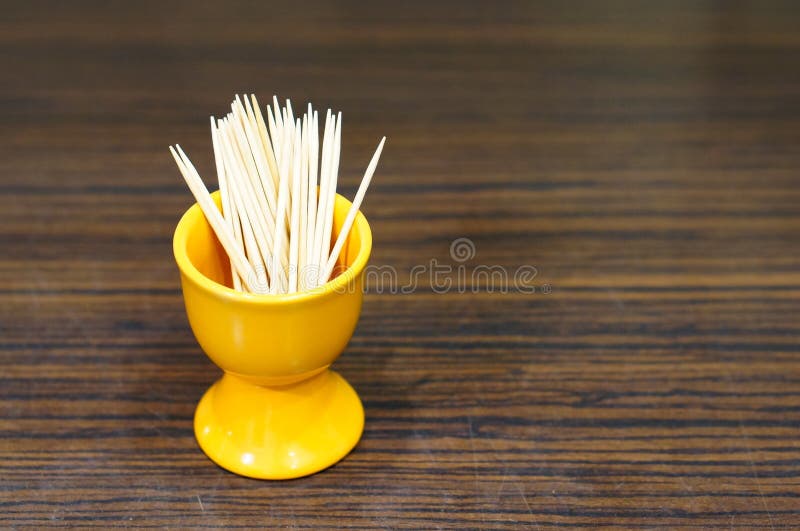 Closeup Shot of the Wooden Toothpicks in a Yellow Ceramic Container ...