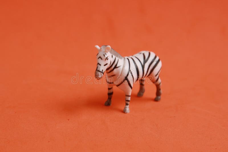 Closeup Shot of Zebra Shaped Plastic Toy Isolated on an Orange ...