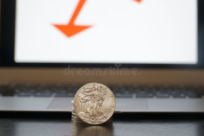 Closeup of Silver Coins with a Drop in Value on the Computer with Red ...