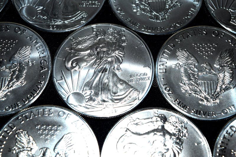 Closeup of Silver Coins Under the Lights Against a Black Background ...