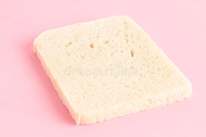 Closeup of a Slice of White Bread without the Rind on a Pink Surface ...