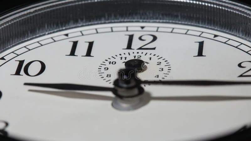 Closeup on Slowly Rotating Clock Face with Fast Moving Clock Hands ...
