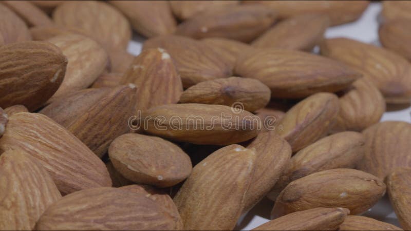 Closeup of a Small Pile of Raw Almonds Scattered on a White Surface ...