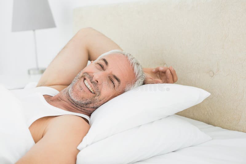 Closeup of a Smiling Mature Man Resting in Bed Stock Image - Image of ...