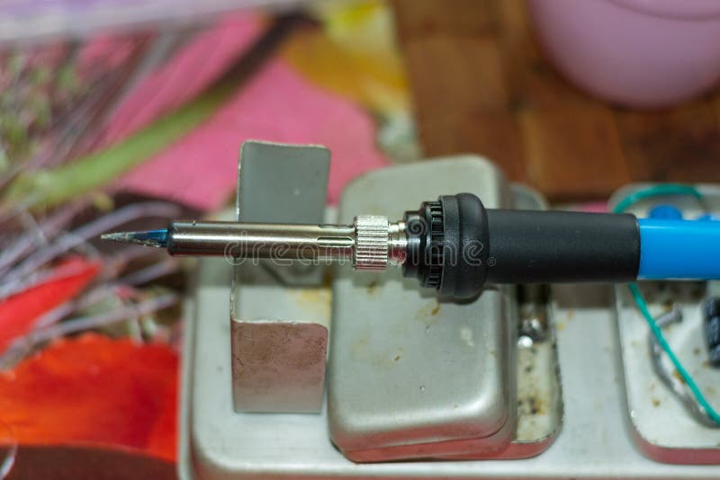 Closeup Soldering Iron on Metal Stand on the Table. Process of ...