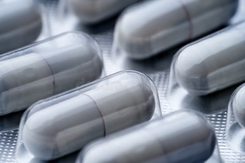 Closeup Of Some Gray Pills In Packaging On A White Background With ...
