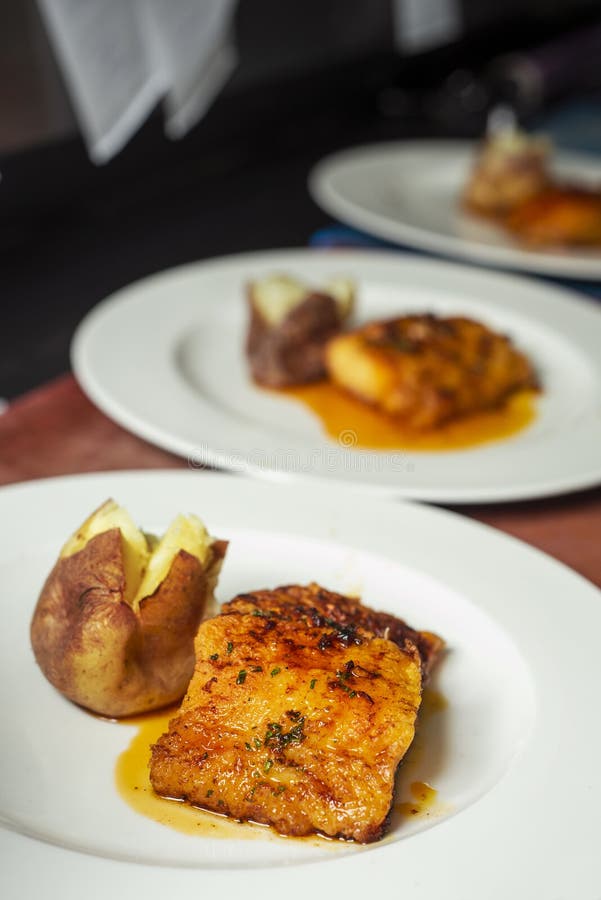 Plates with Battered Cod and Roasted Potatoes Stock Photo - Image of ...