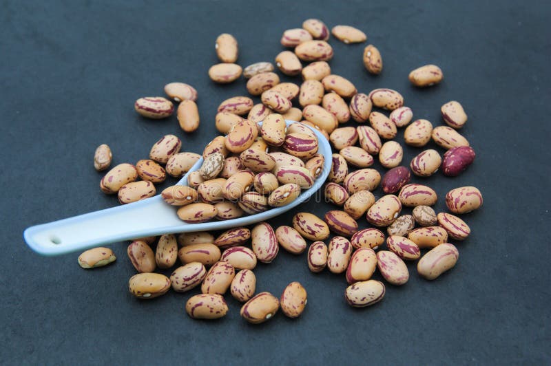 Closeup of a Spoon with Beans Scattered on the Table Stock Photo ...