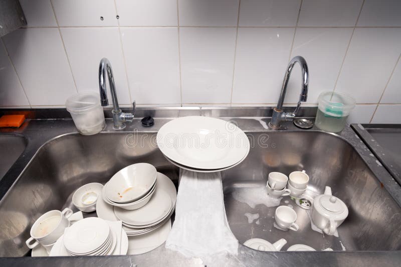 Stack Of Dirty Dishes And Silverware In Sink With Bubbles Stock Photo ...