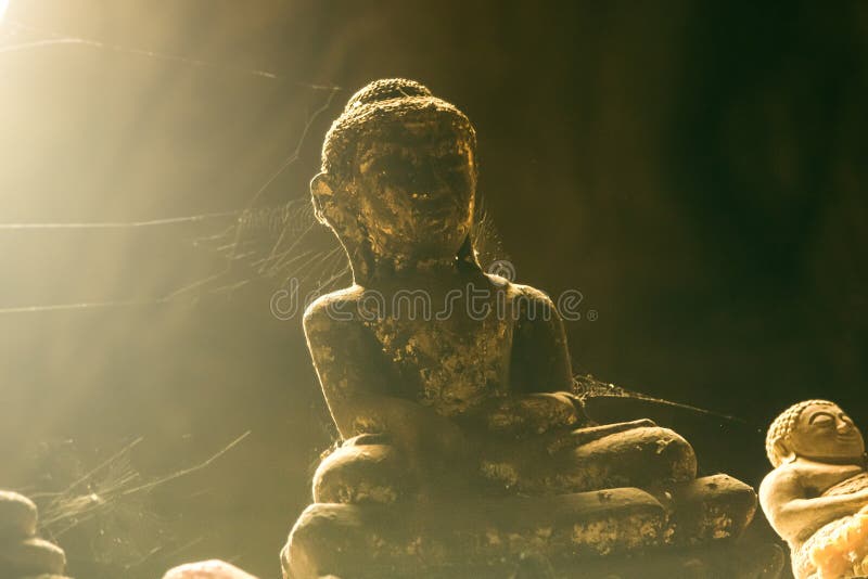 Closeup of Stone Buddha Statues Covered in Spider Web in a Cave. Stock ...