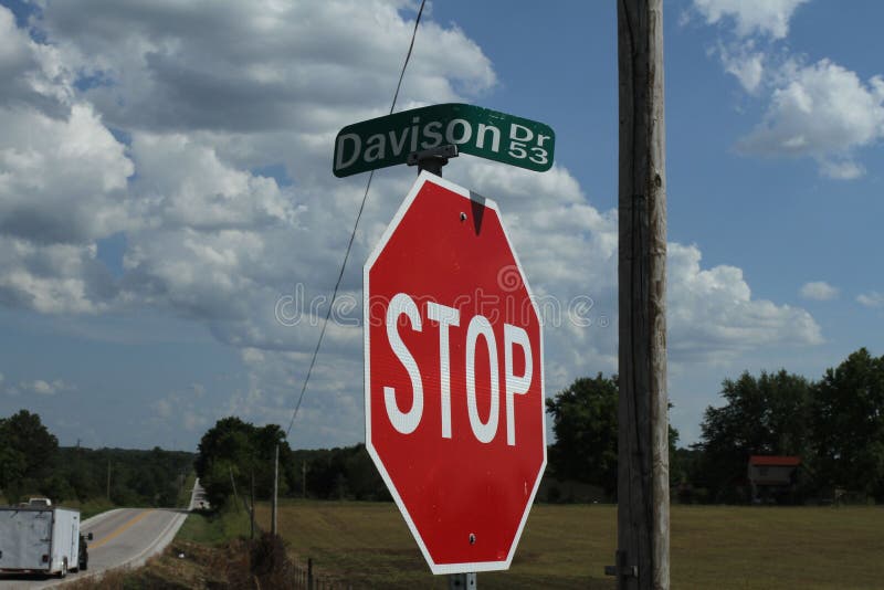 Closeup of a Stop Sign on a Road with Field Under the Cloudy Sky Stock ...