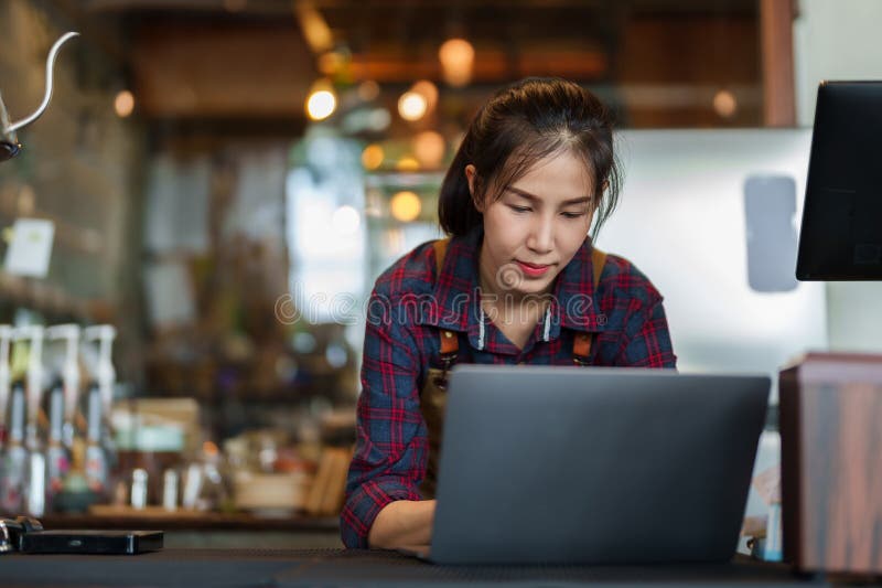 Closeup of Store Owner Smiling when Typing on Laptop Computer because ...