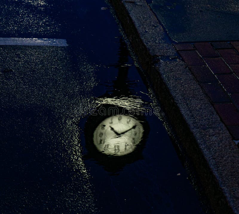 Closeup of the Street Clock S Reflection in the Puddle. Stock Image ...