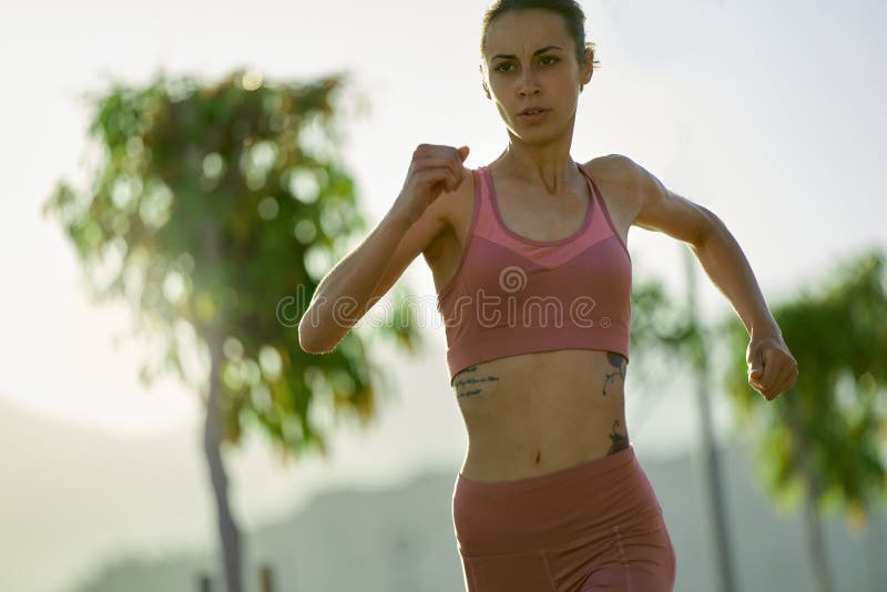 Closeup of Strong Athletic Woman Runner in Fast Motion Training ...