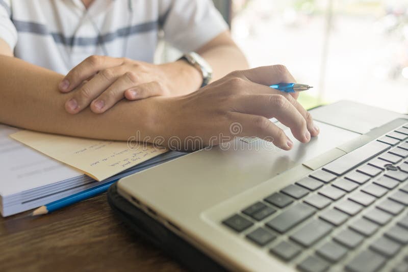 Closeup of Human Hand Holding Pen and Using Laptop Touchpad Stock Photo ...
