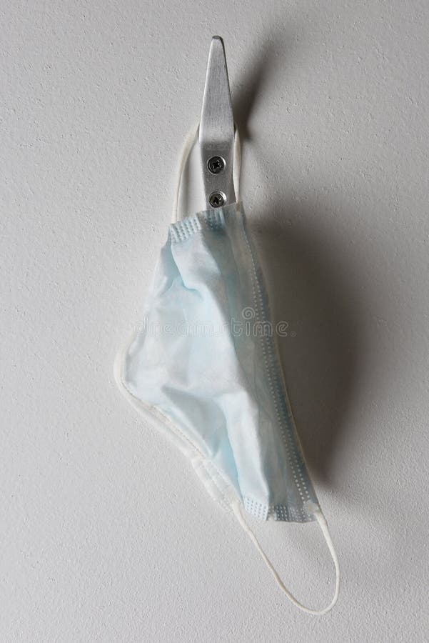 Closeup of a Surgical Mask Hanging from a Hook on a Wall Stock Image ...