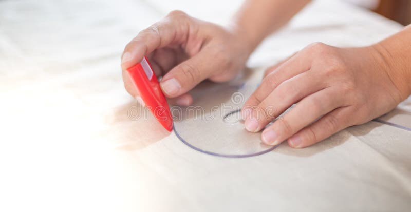 Closeup of Tailors Table with Female Hands Tracing Fabric with Curve ...