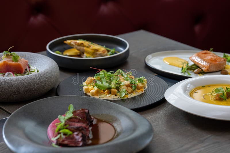 Closeup of Tasty Multiple Cooked Dishes in Different Ceramic Plates on ...