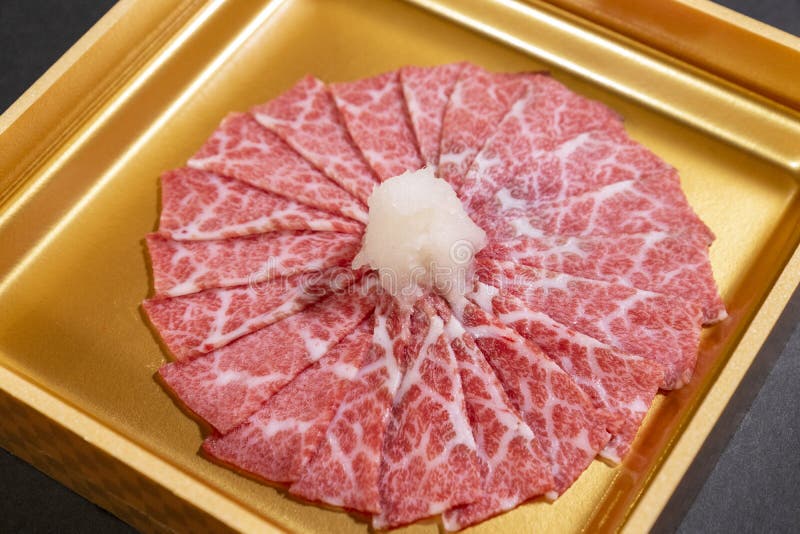 Closeup of Thin Raw Wagyu Slices on a Board on the Table in the Kitchen ...