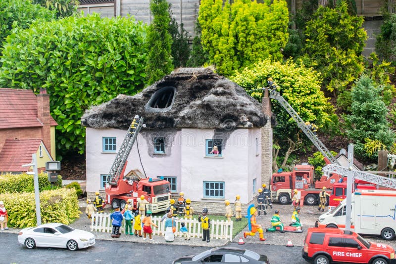Closeup of Tiny Model Cottage with the Roof on Fire at a Model Village ...
