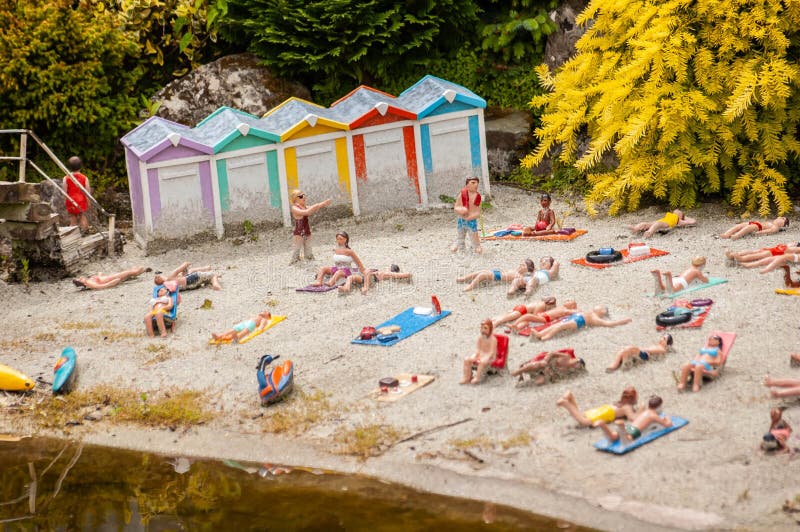 Closeup of Tiny Model People Sitting on a Beach Stock Photo - Image of ...