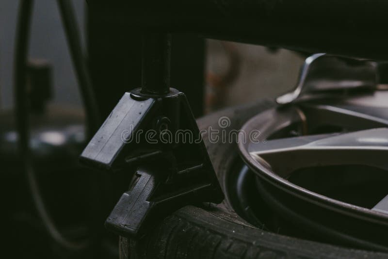 Closeup of a Tire in a Workshop with a Tool Taking Off the Rim Stock ...