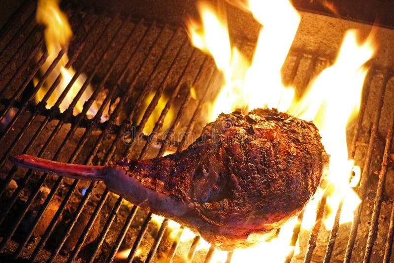Closeup of Tomahawk Rib Eye on a Flaming Grill Stock Photo - Image of ...