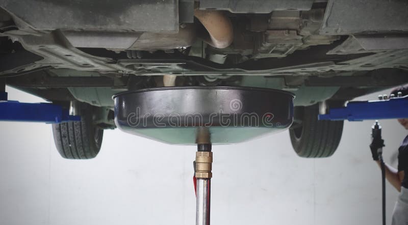 Closeup Tool for Mechanic Draining Engine Oil from a Car for an Oil ...