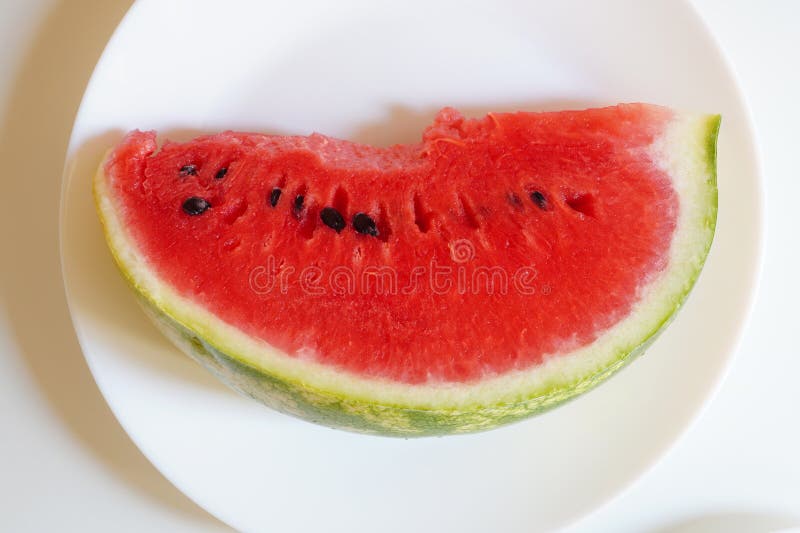 Closeup of Watermelon Slice on White Plate Stock Photo - Image of space ...