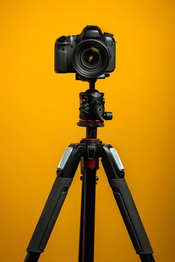 Closeup of a Tripod with a Camera in it Stock Photo - Image of flash ...