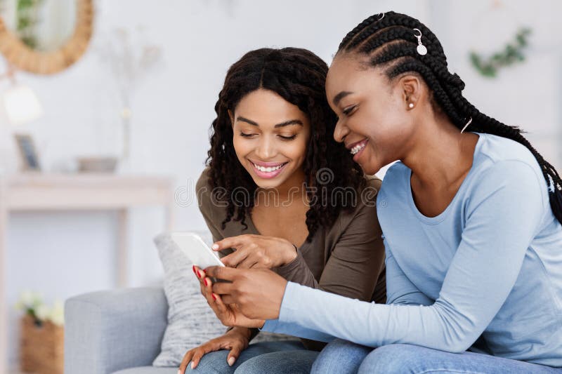 Closeup of Two African Women Using Mobile Phone Stock Photo - Image of ...