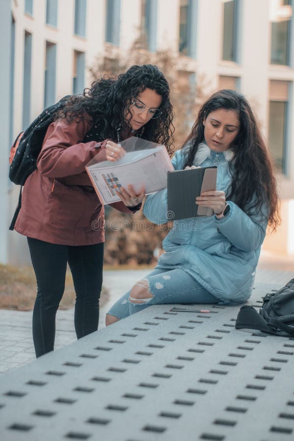 Closeup of Two Caucasian Students Checking Their Papers and Tablets ...