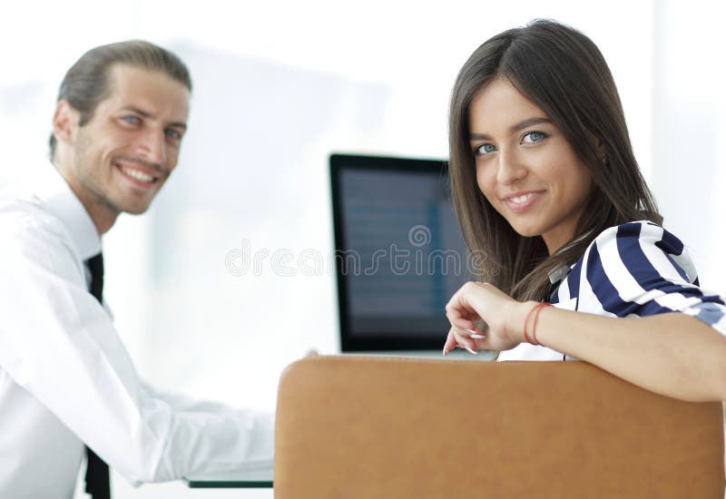 Two Young Employee Sitting Behind a Desk Stock Image - Image of online ...