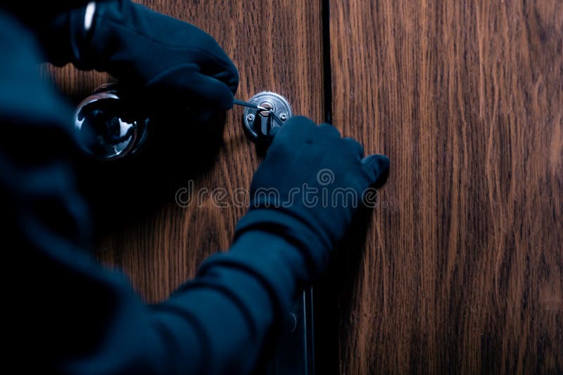 Robber in Black Mask Cracking Door with Metal Picklock Stock Image ...