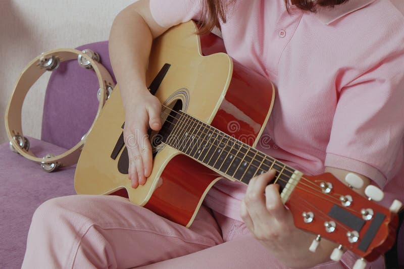 Closeup of an Unrecognizable Woman Guitarist Plucking Strings of ...