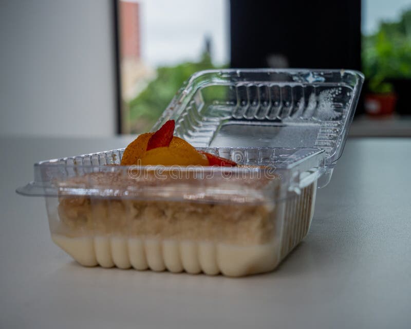 Closeup of Vanilla Cake with Fruits in a Plastic Box on a White-colored ...