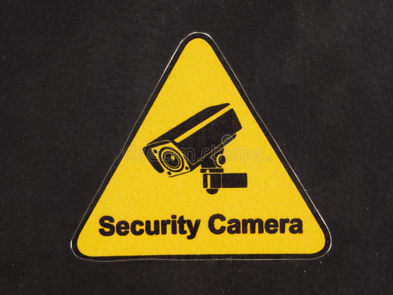 Yellow Triangular Security Camera Warning Sign Attached To Textured ...