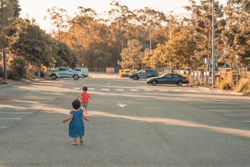 Closeup View of Children Running in a Car Parking Area Stock Photo ...