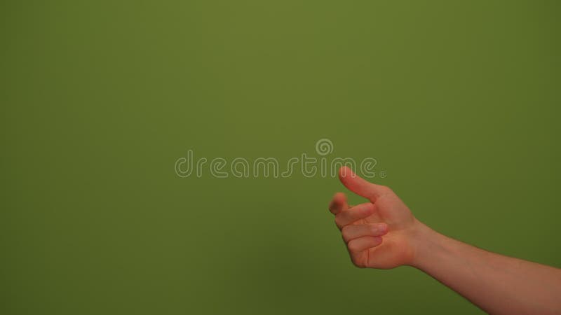 A Closeup View of a Hand Making Gestures in Front of a Lush Green ...