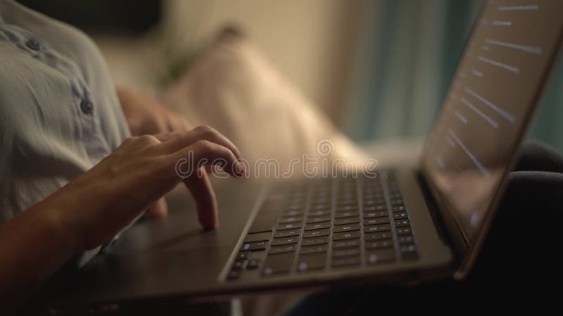A CloseUp View of Hands Actively Typing on a Laptop while Working from Home in a Cozy ...