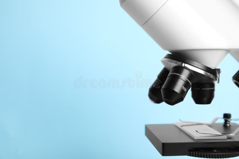 Closeup View of Modern Microscope on Blue Background. Medical Equipment ...