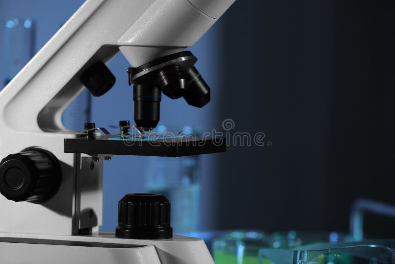 Closeup View of Modern Microscope with Glass Slide on Blurred ...
